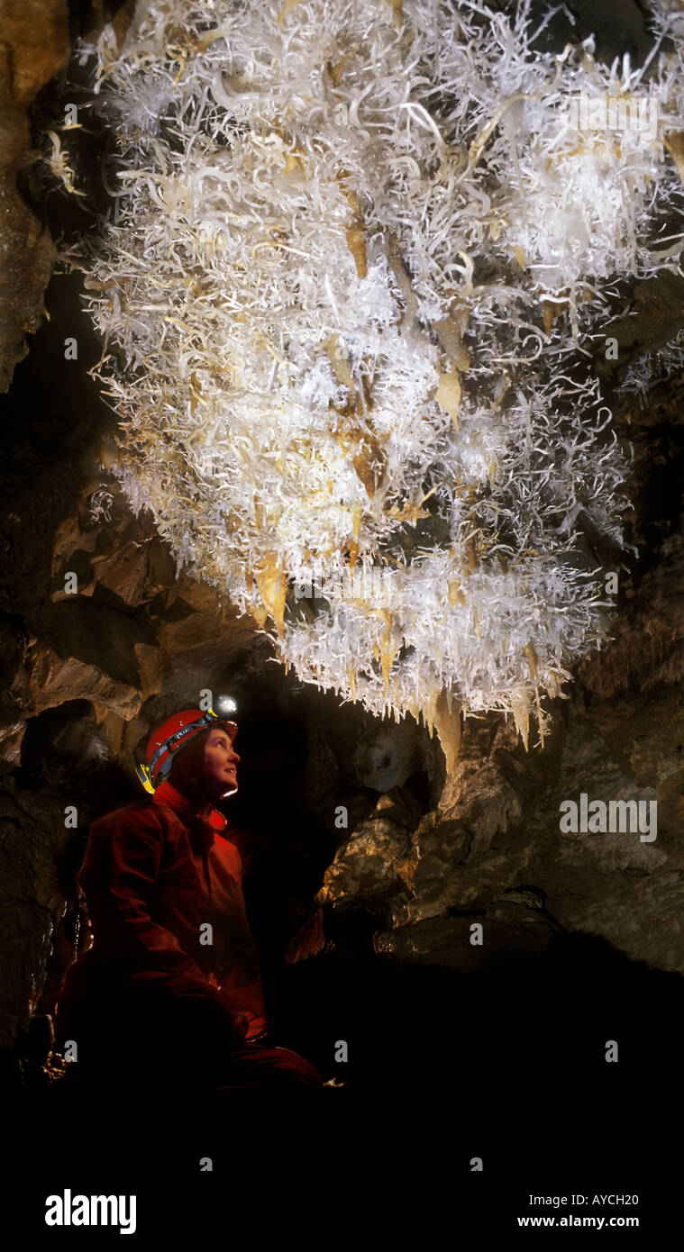 Female caver looking at helictites in a California cave USA Stock Photo ...
