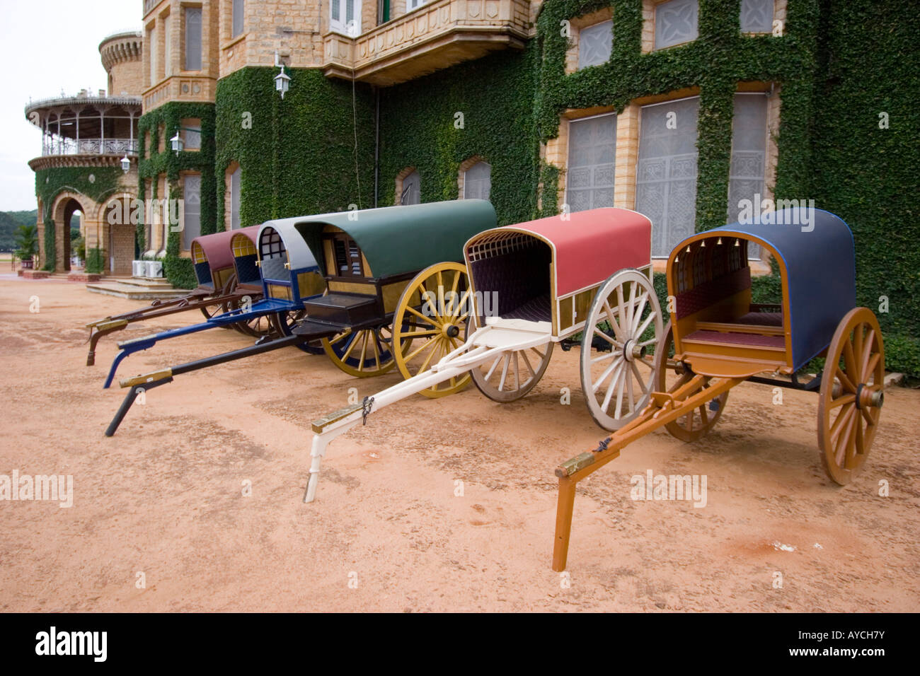 Old fashioned horse drawn rickshaw carriages outside Bangalore Palace ...