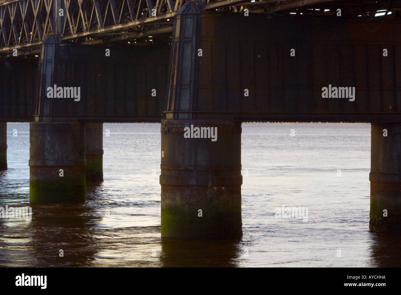 Silhouette view of support legs on the railway bridge at sunset across ...