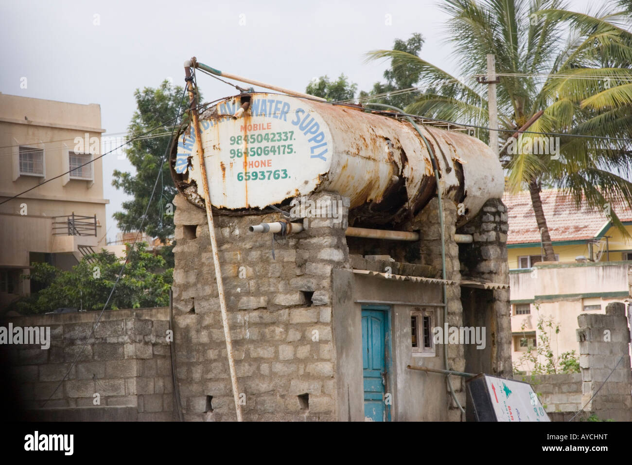 Dirty old water storage tank in Banaglore India Stock Photo - Alamy
