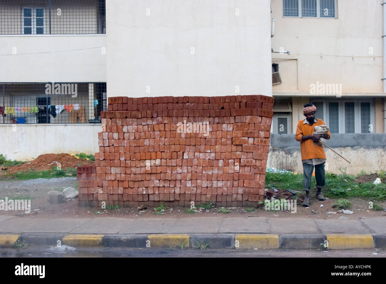 Pile of red building bricks in Bangalore India Stock Photo - Alamy