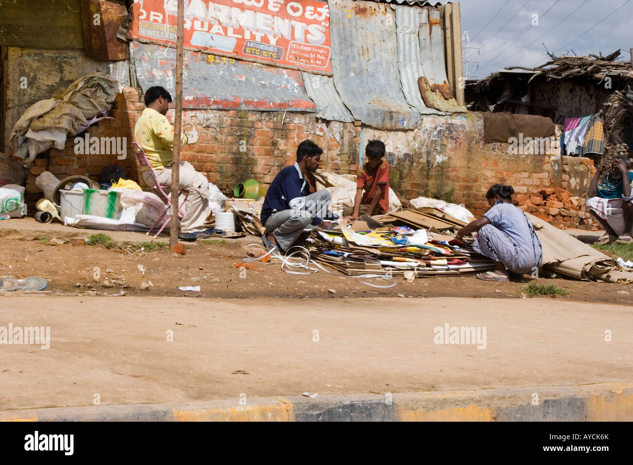 Street scene in poor area of Bangalore residents processing cardboard ...