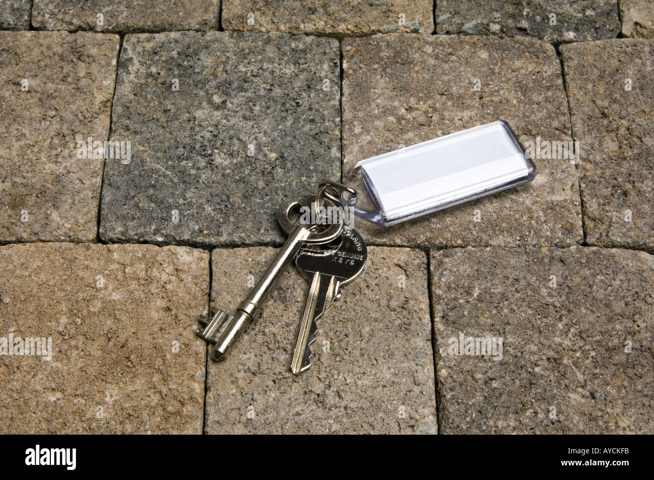 A set of house keys on a brick ground Stock Photo - Alamy