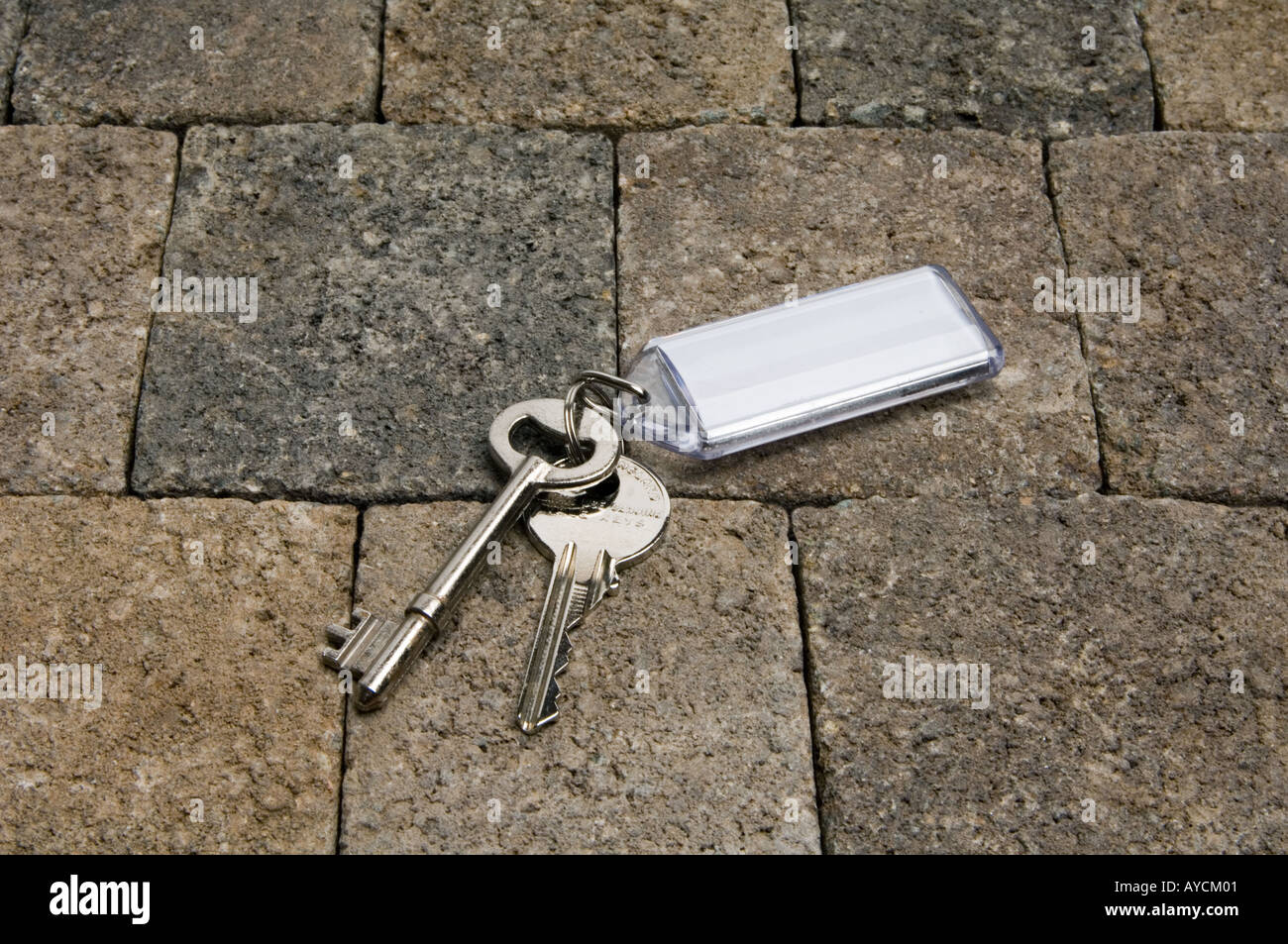 A set of house keys on a brick ground Stock Photo - Alamy