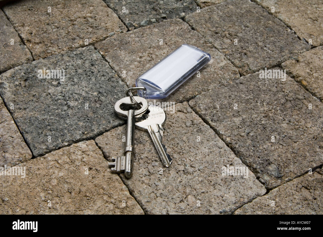 A set of house keys on a brick ground Stock Photo - Alamy