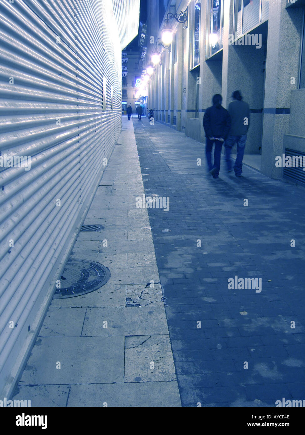 two men walking down dark alley at night Stock Photo - Alamy