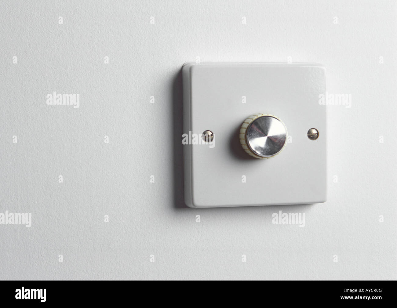 Single white plastic light dimmer switch on white wall Stock Photo - Alamy