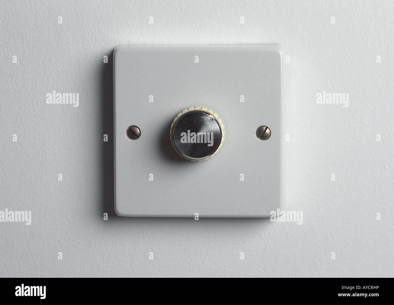 Single white plastic light dimmer switch on white wall Stock Photo - Alamy