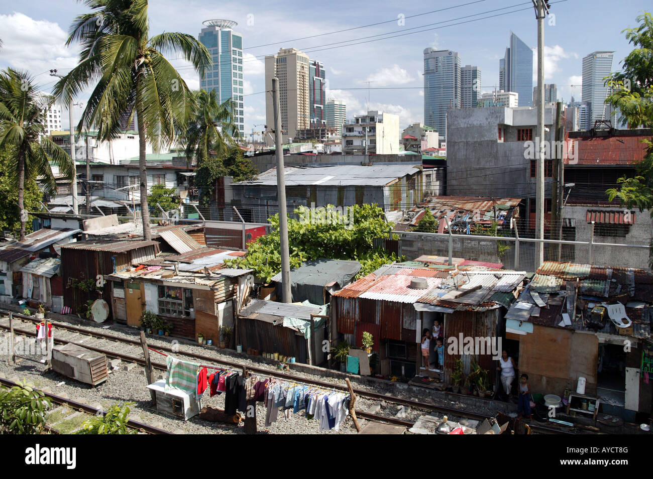 Manila, The Philippines: Slum huts in front of the skyline of the bank district Makati Stock ...