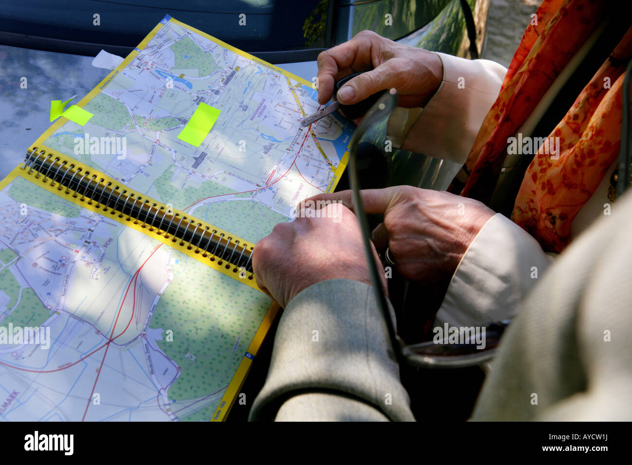 during a summer trip reading of the maps on the back of a car Stock ...