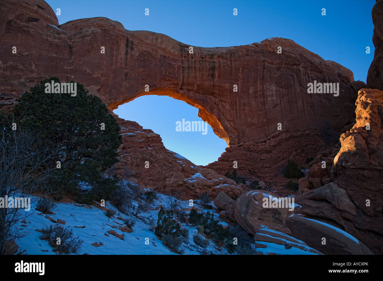 Sunset glow on North Window backside with winter snow at Arches ...