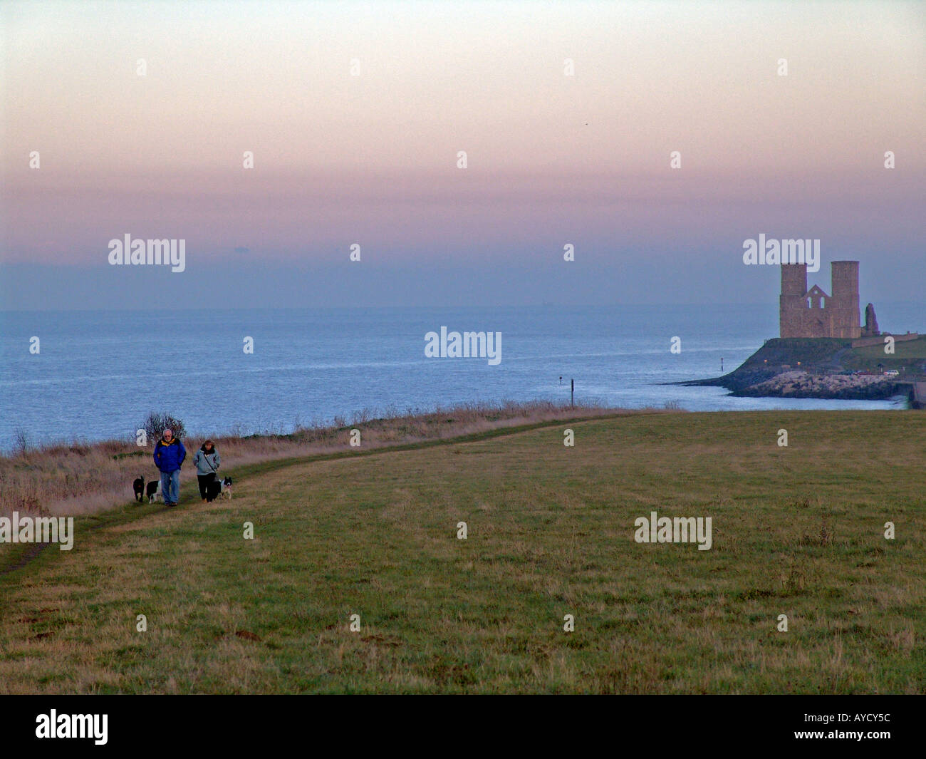 hiking along the cliff tops at sunset norman church in background ...