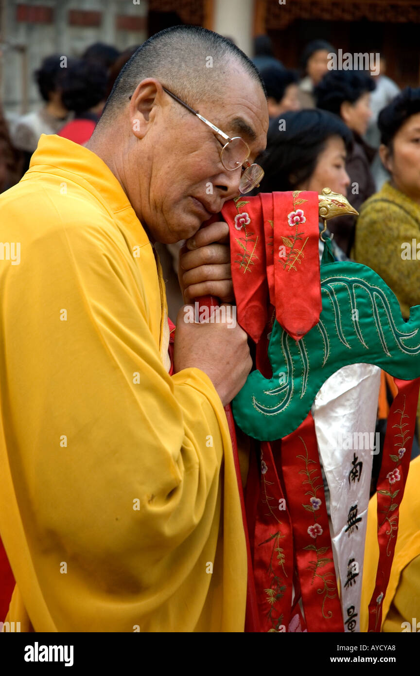 An elder Buddhist monk resting during a religious procession at Jingan ...