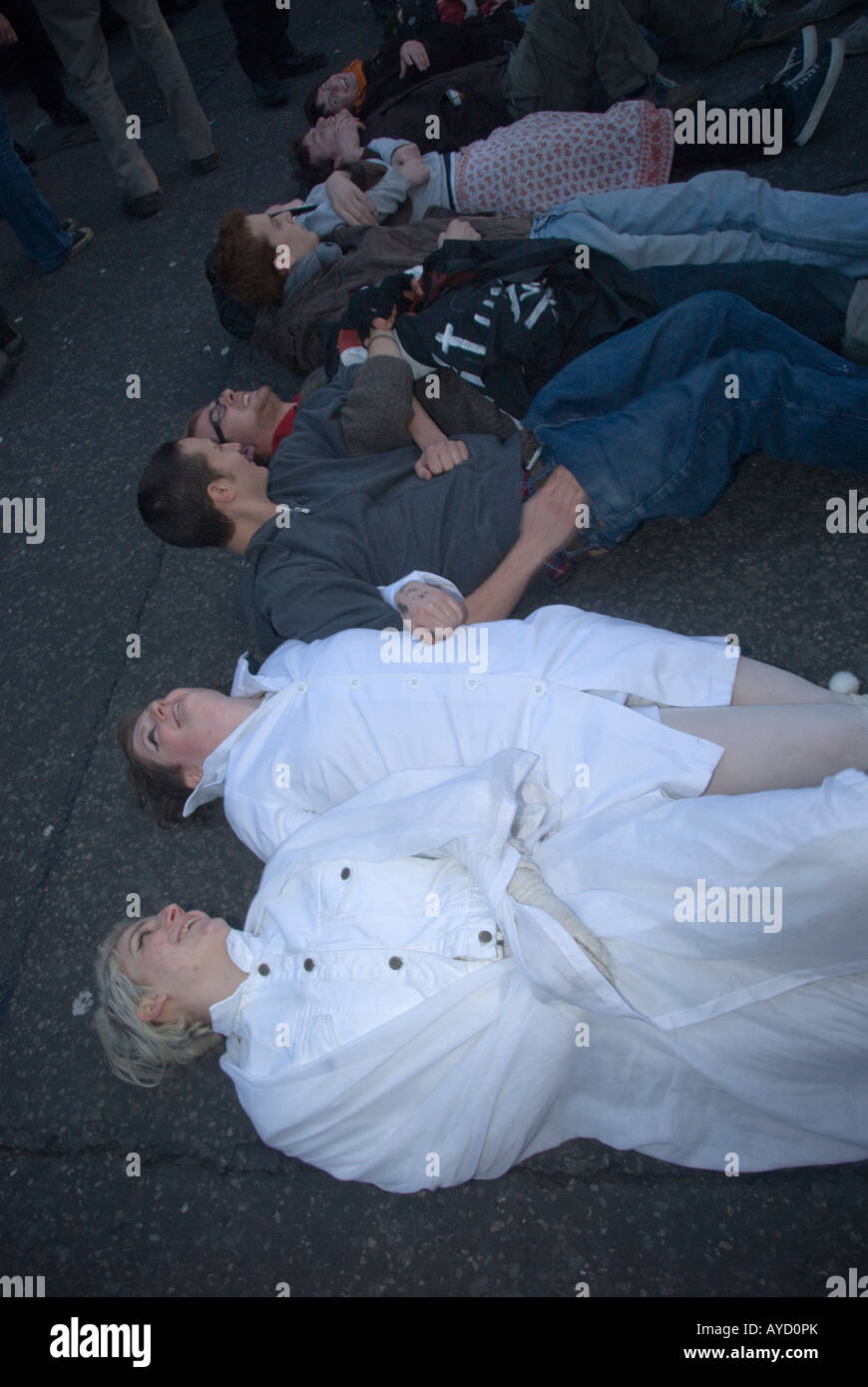 A row of people lie down in Whitehall outside Downing Street, London in ...