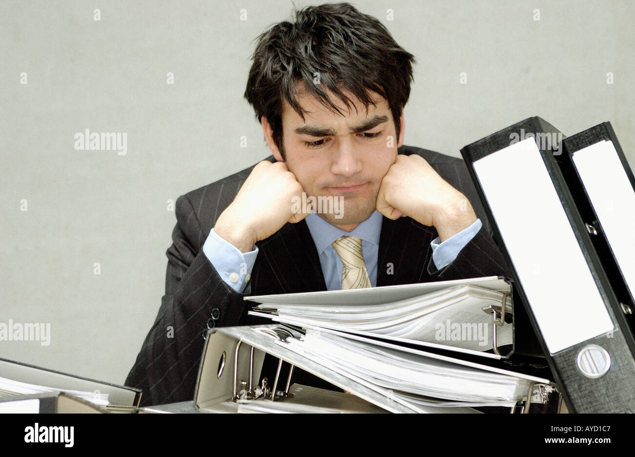 Young man sitting messy desk hi-res stock photography and images - Alamy