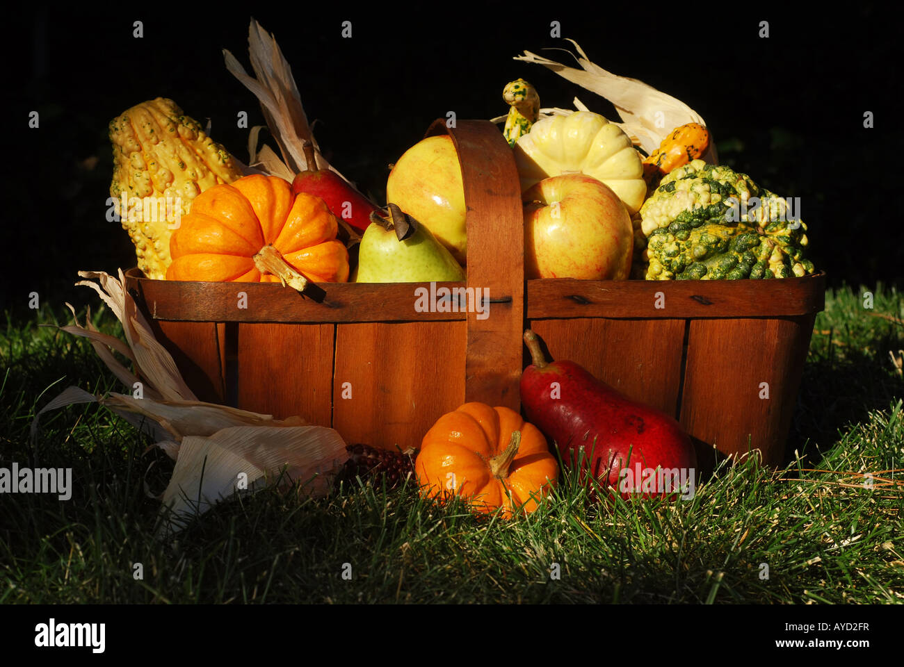 Vintage wooden fruit basket filled with autumn fruits and vegetables ...