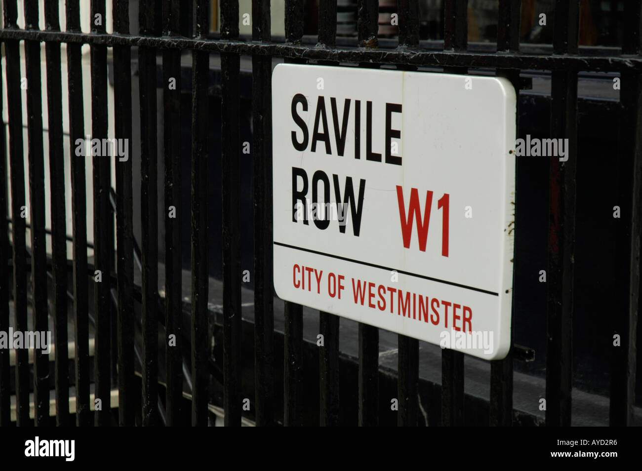 Savile Row road sign and railings City of Westminster London England ...