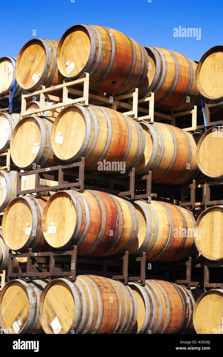 Wine barrels stacked high against a clear blue sky Stock Photo - Alamy