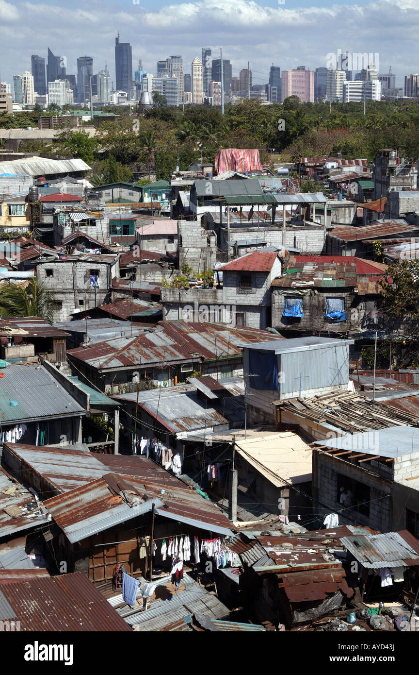 Manila, The Philippines: Slum huts in front of the skyline of the bank district Makati Stock ...