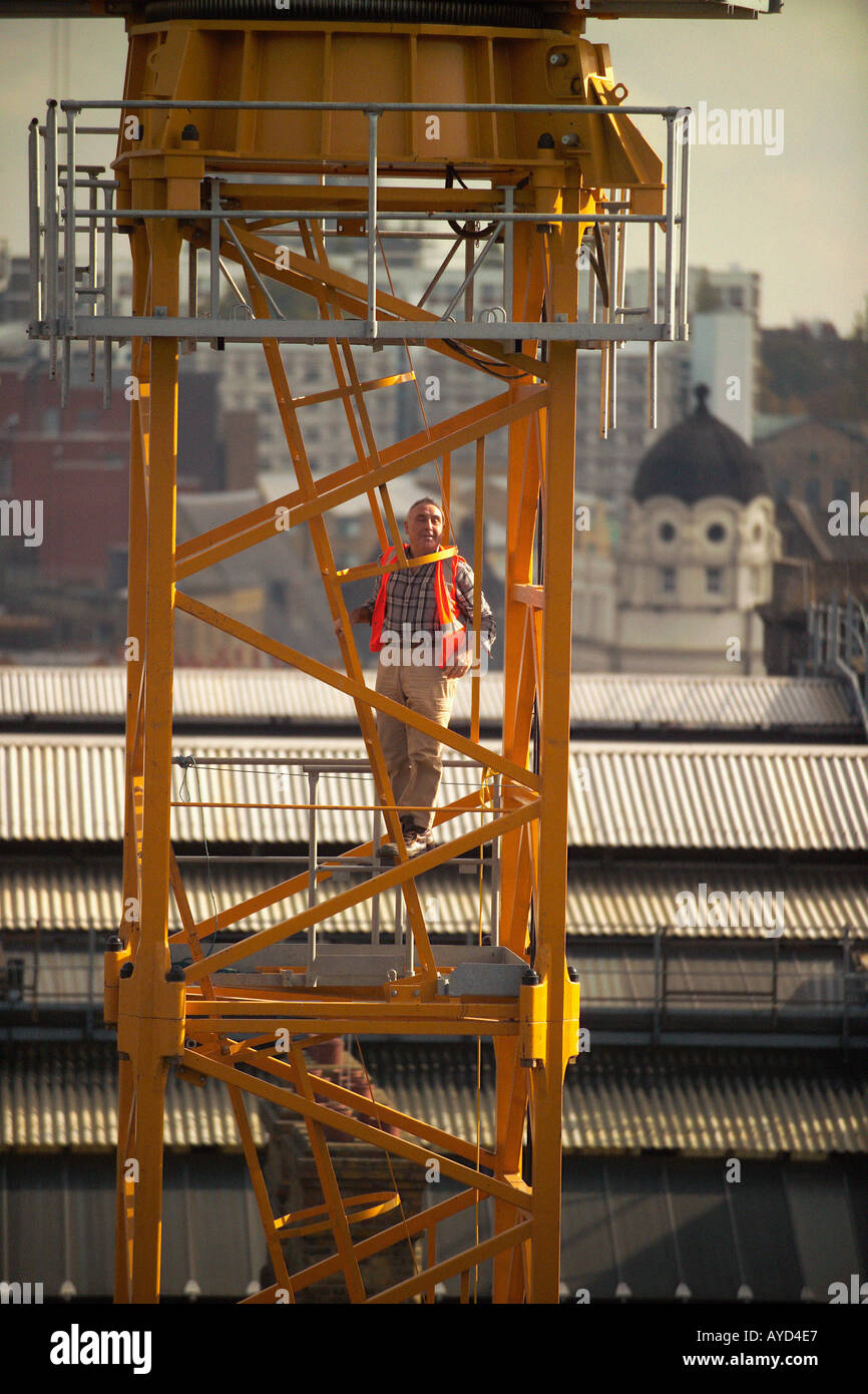 Construction worker climbing a crane Stock Photo - Alamy