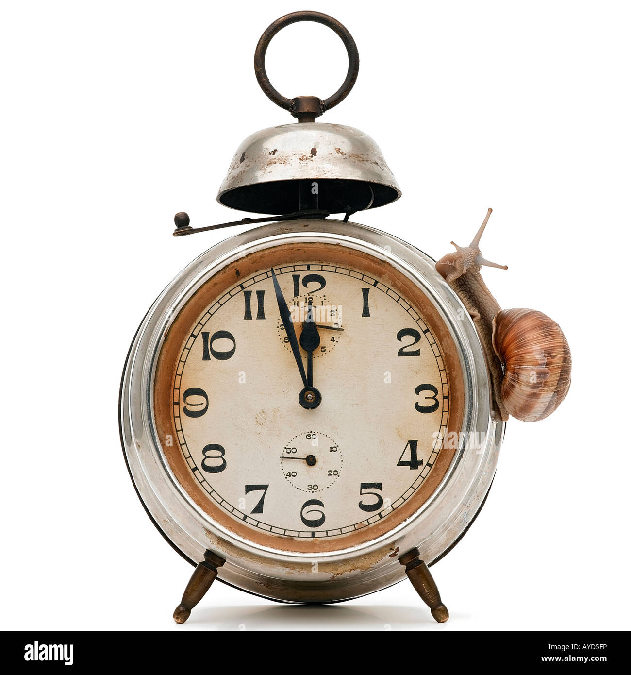 a snail climbing an old alarm clock Stock Photo - Alamy