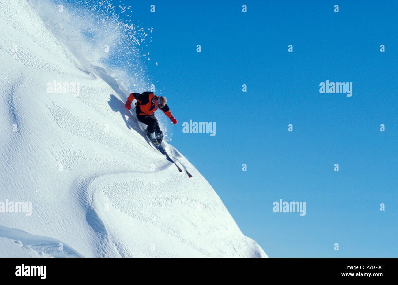Extreme skier coming down steep slope deep powder Stock Photo - Alamy