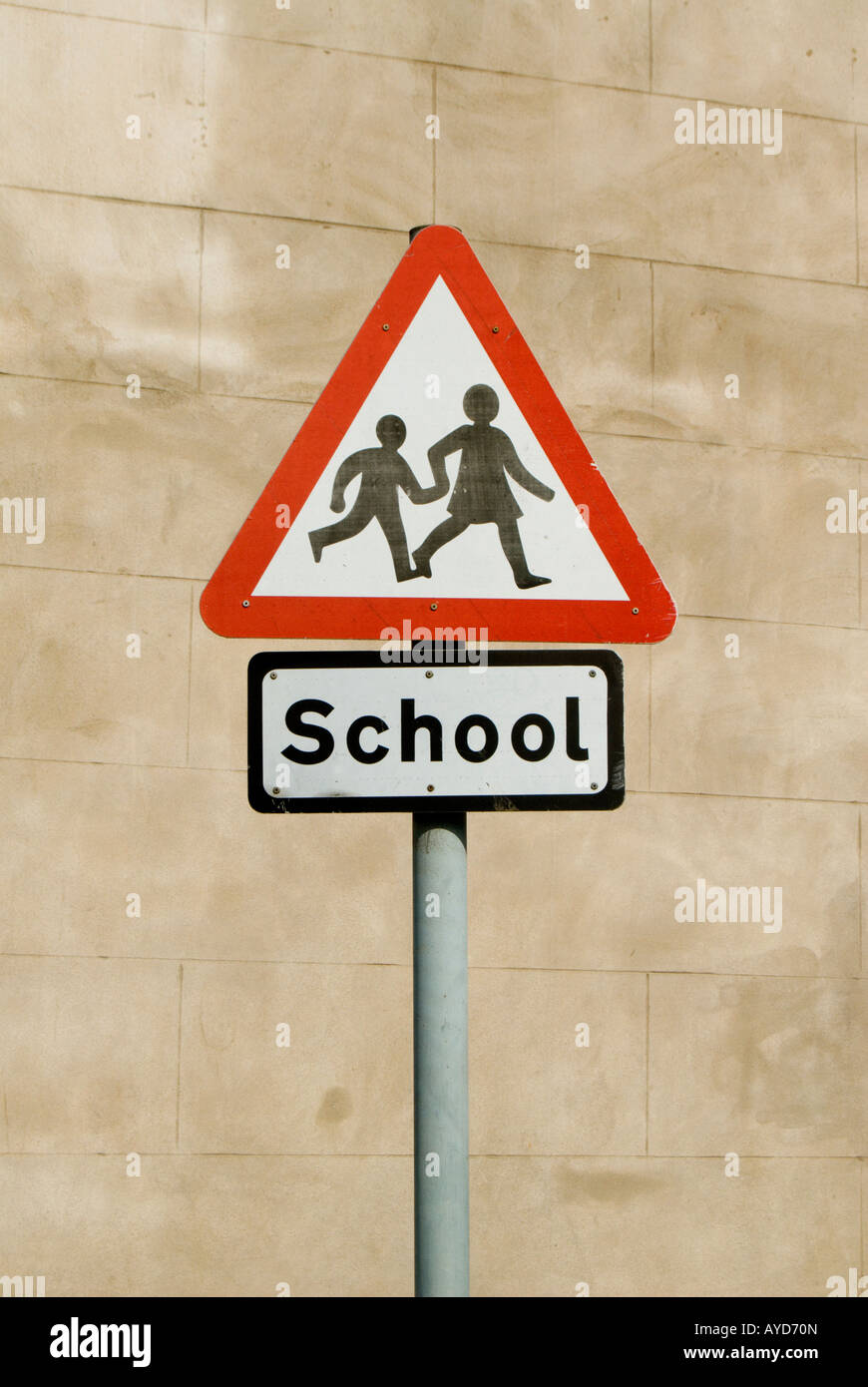 School warning road sign in front of freshly rendered wall. England ...