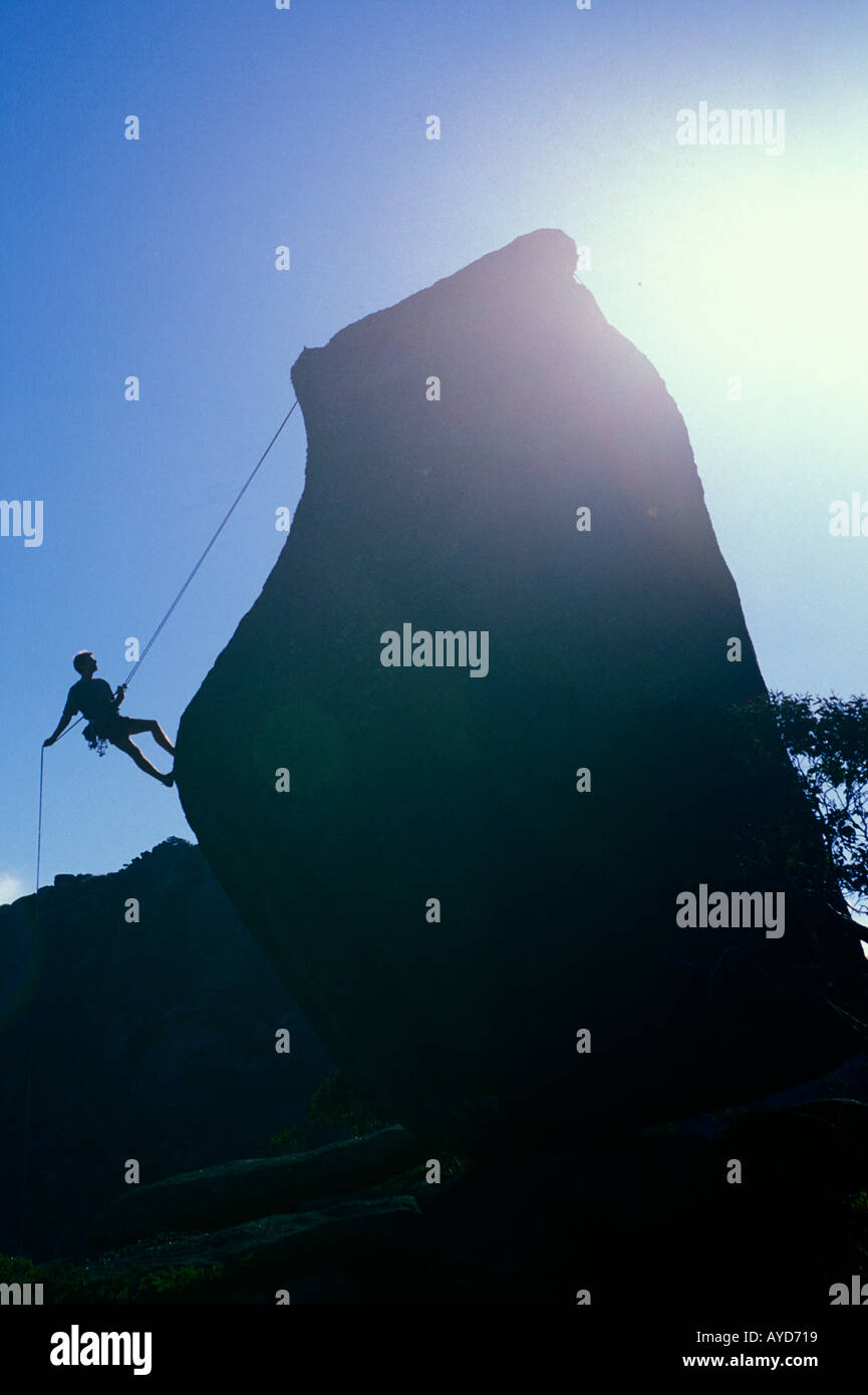 bouldering on a large rock against the sun Stock Photo - Alamy