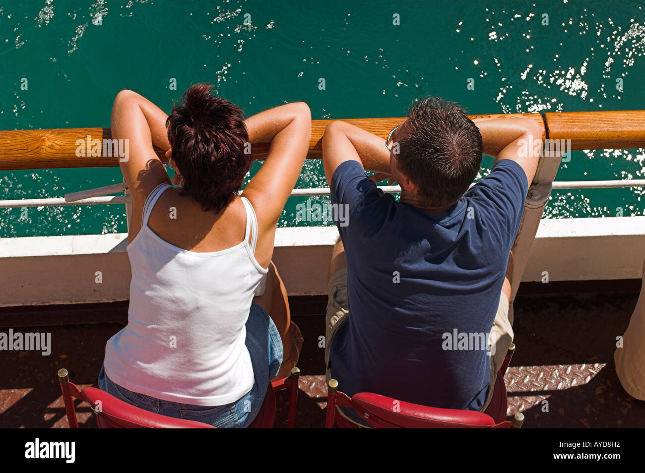 Two passengers resting on the hand rail of a ferry boat Lazise Lake ...