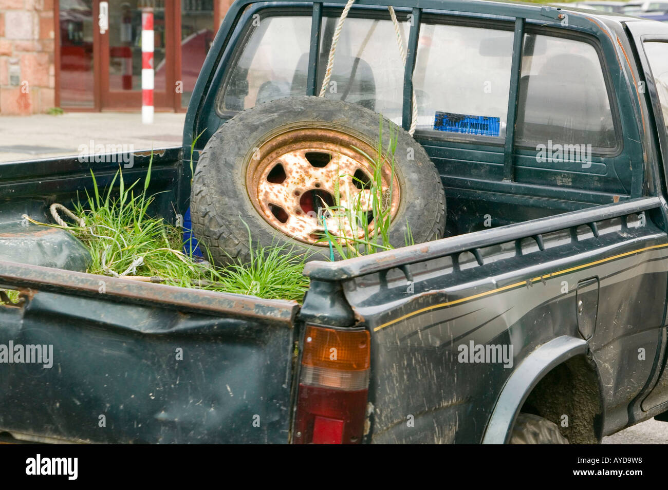 an old truck with grass growing in the back in lochinver, Scotland, UK ...