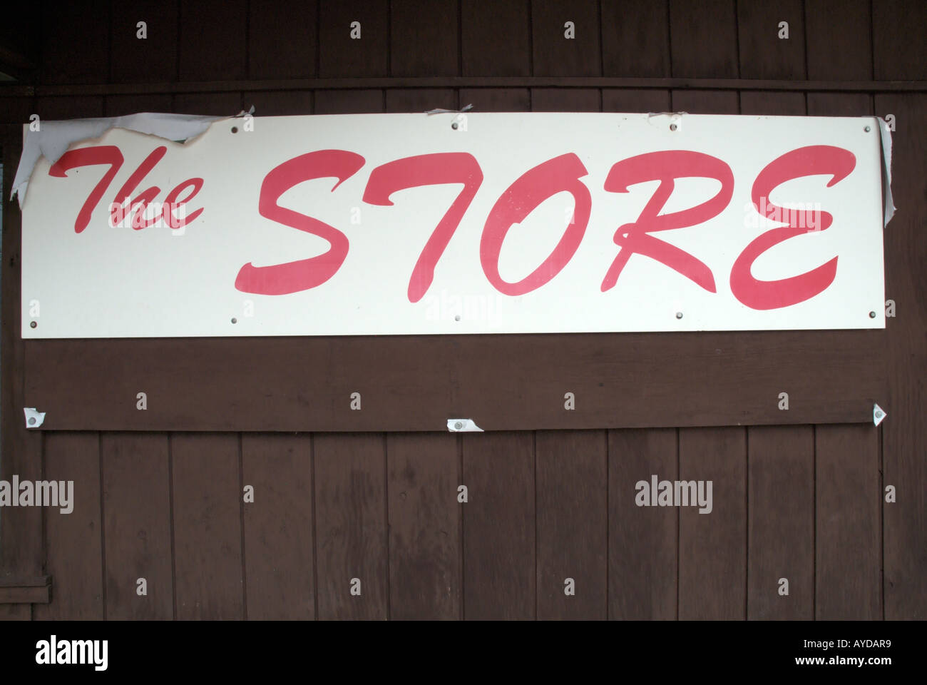 The Store Sign attached to a wall painted brown Stock Photo - Alamy