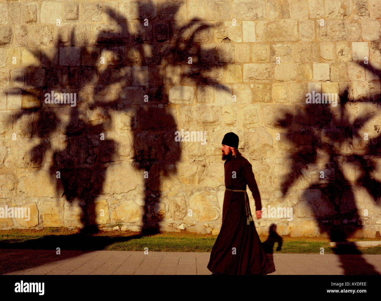 Israel Jerusalem Old City Russian Orthodox priest palm trees shadows on ...