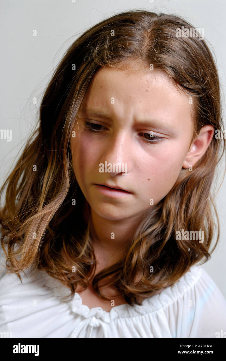 Sullen teenage girl looking down Stock Photo - Alamy
