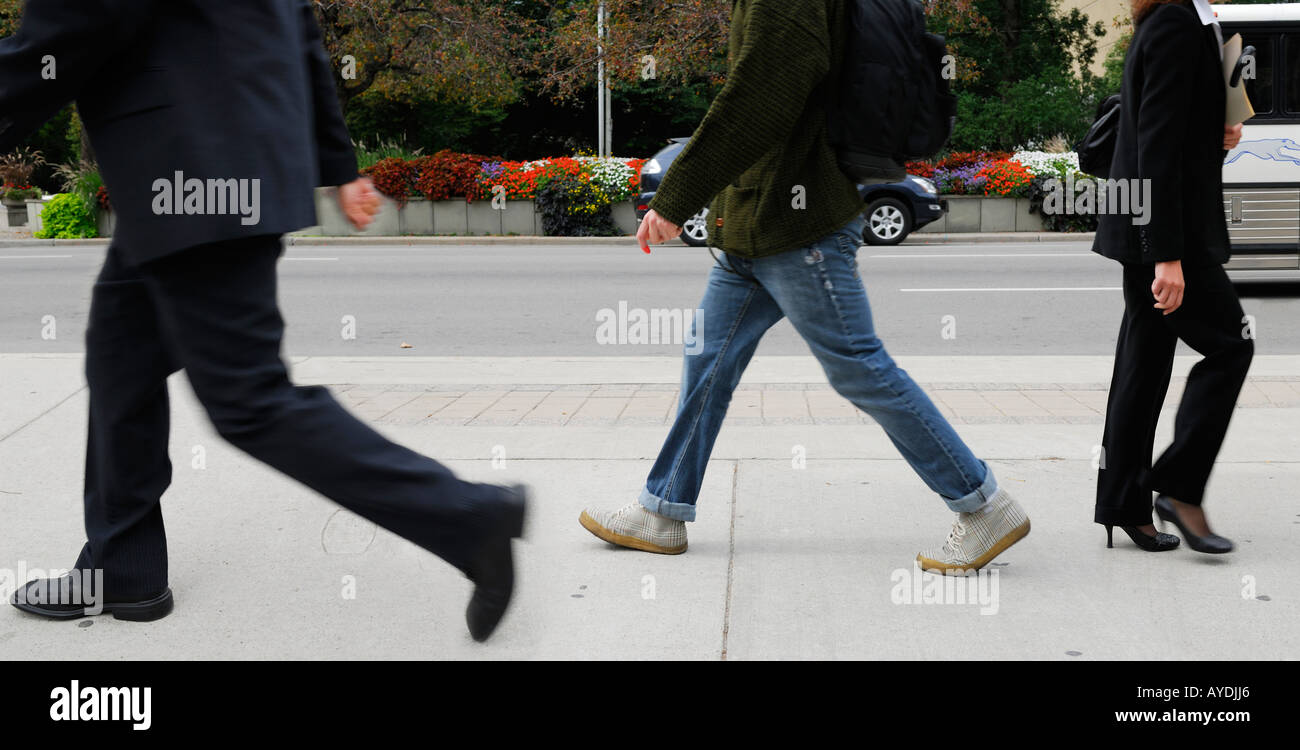 Three pedestrians walking on a sidewalk Toronto Stock Photo - Alamy