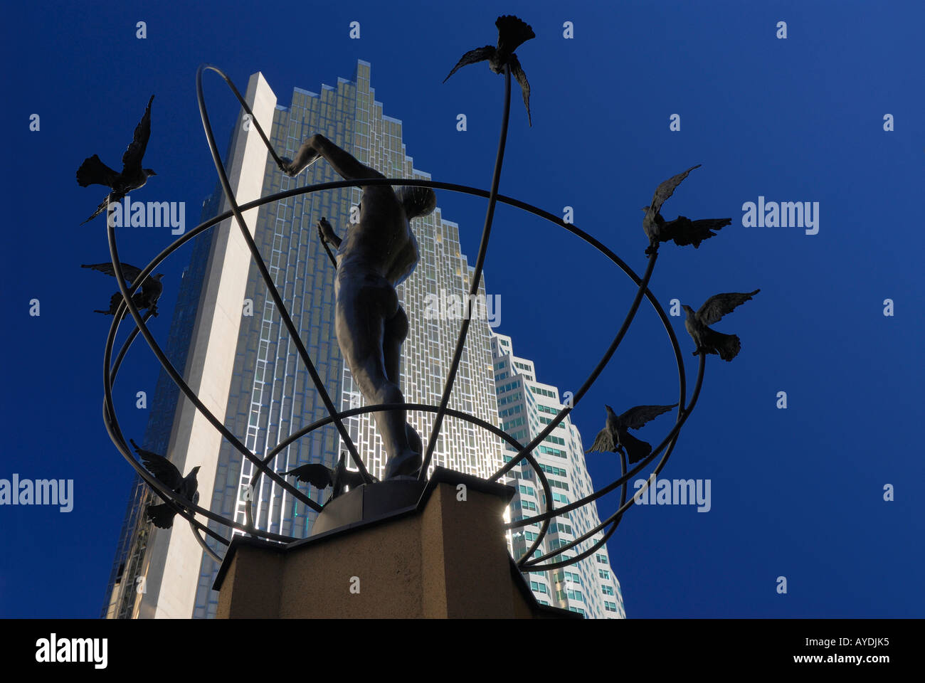 Toronto sculpture of man building a peaceful world with gold bank tower ...