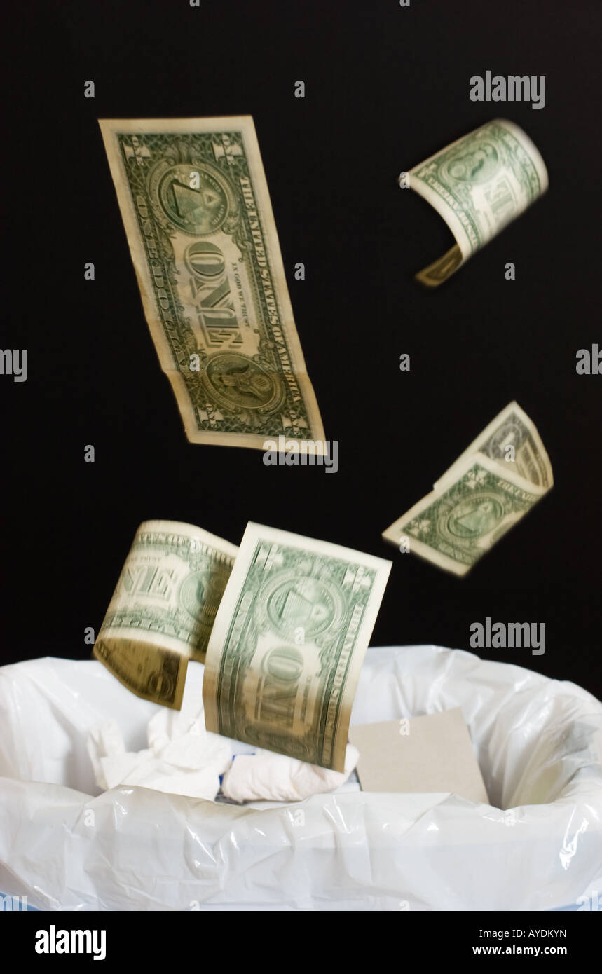 The value of the dollar falls until it ends up in the trash Stock Photo ...