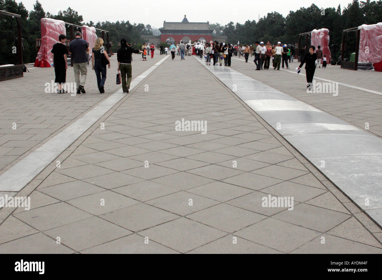 Chinese tourists walk down the path to the Temple of Heaven in Beijing ...