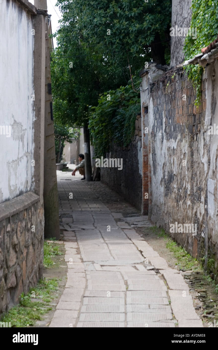 Chinese man resting in an alley in Suzhou China Stock Photo - Alamy
