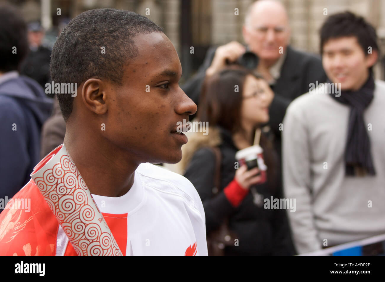 A Beijing 2008 Olympic Torch Carrier at Somerset House with Onlookers ...