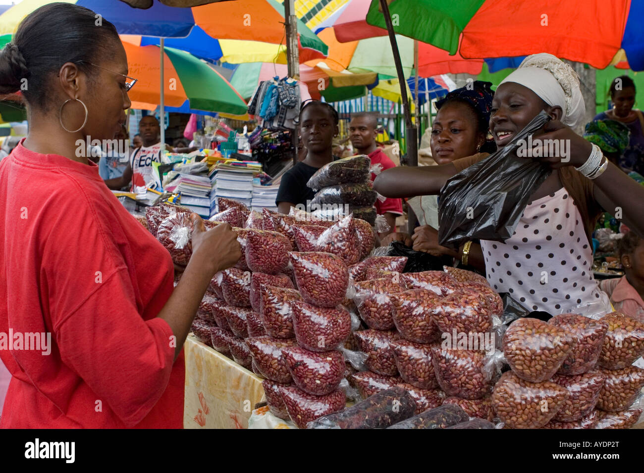 African Gabonese woman buying nuts from a stallholder, Mont-Bouet ...