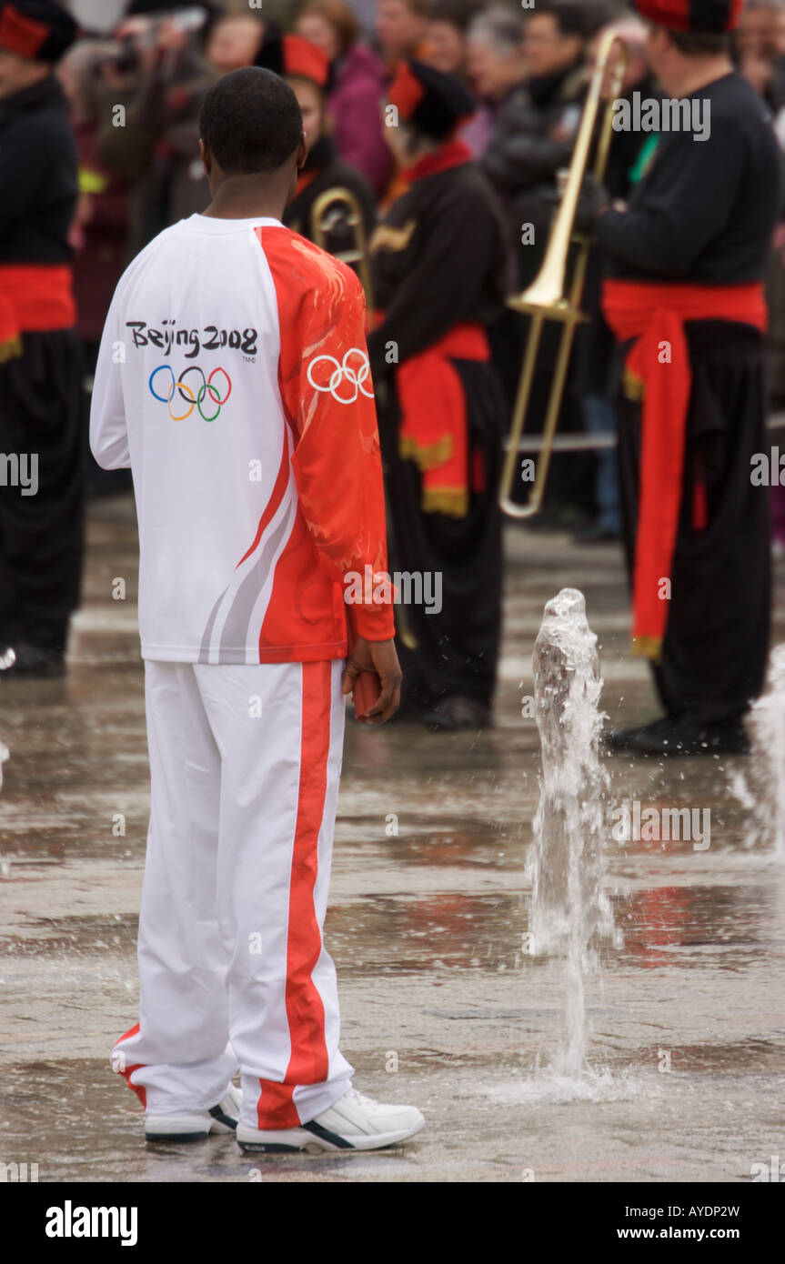 A Beijing 2008 Olympic Torch Carrier at Somerset House with a Brass ...