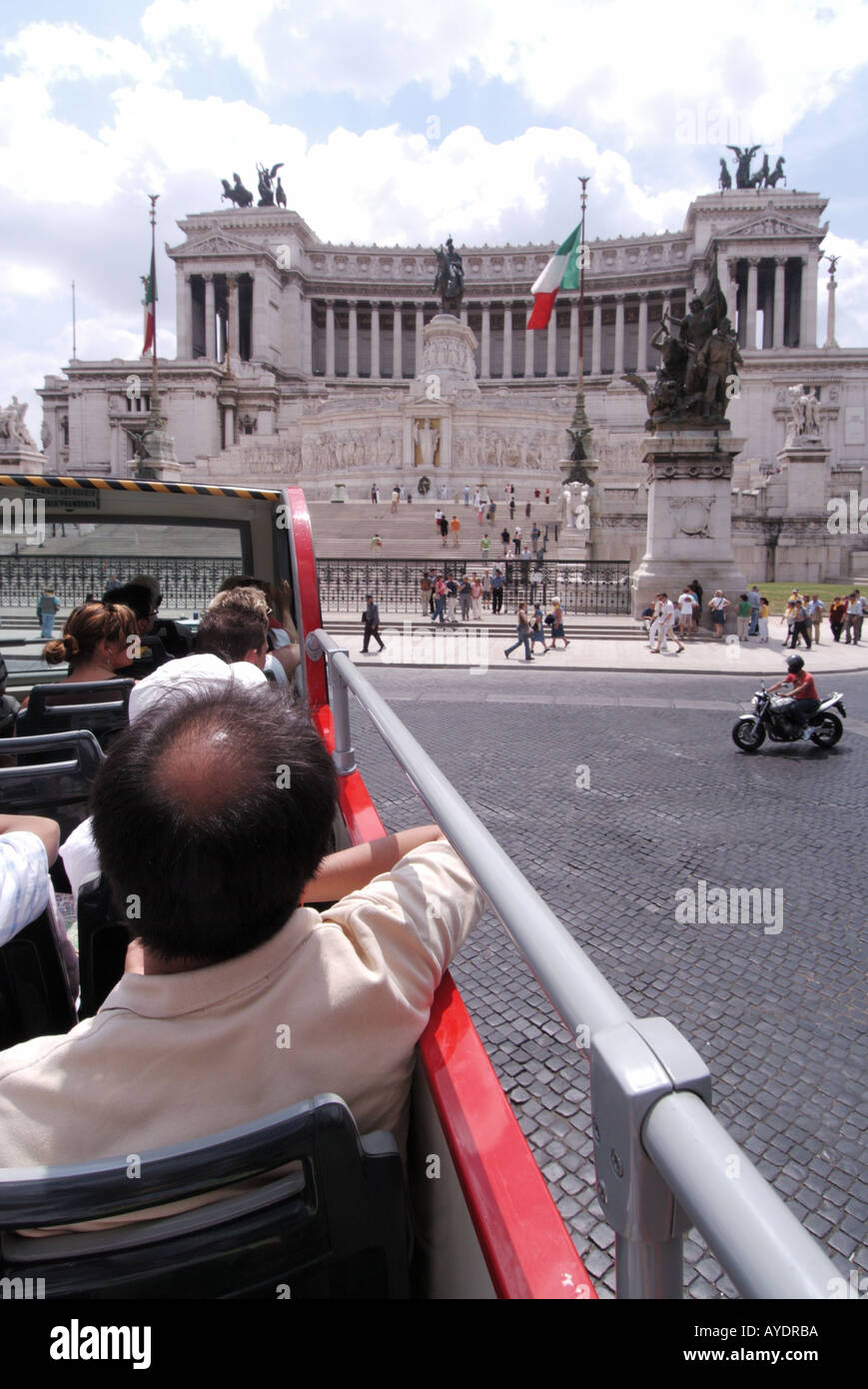 Back view Rome tourist passengers seated top deck on open top double ...