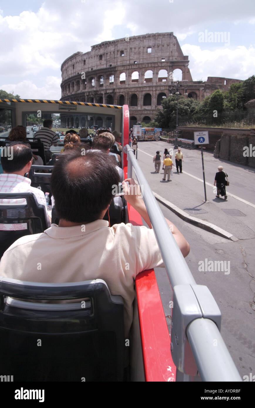 Rome tourists on open top bus approaching the Roman coliseum Stock ...