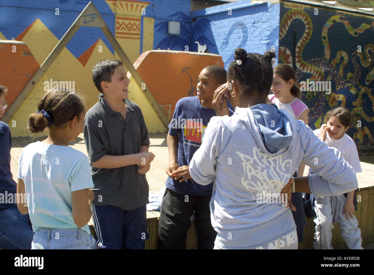 primary students in playground talking together Stock Photo - Alamy