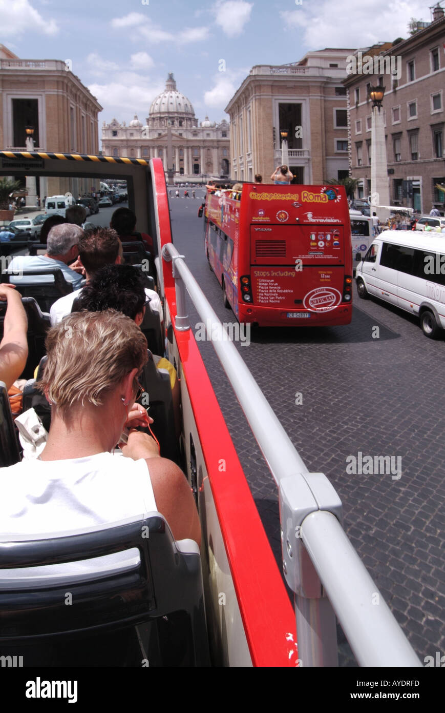 Back view tourists seated on board red Stop & Go double decker open top ...