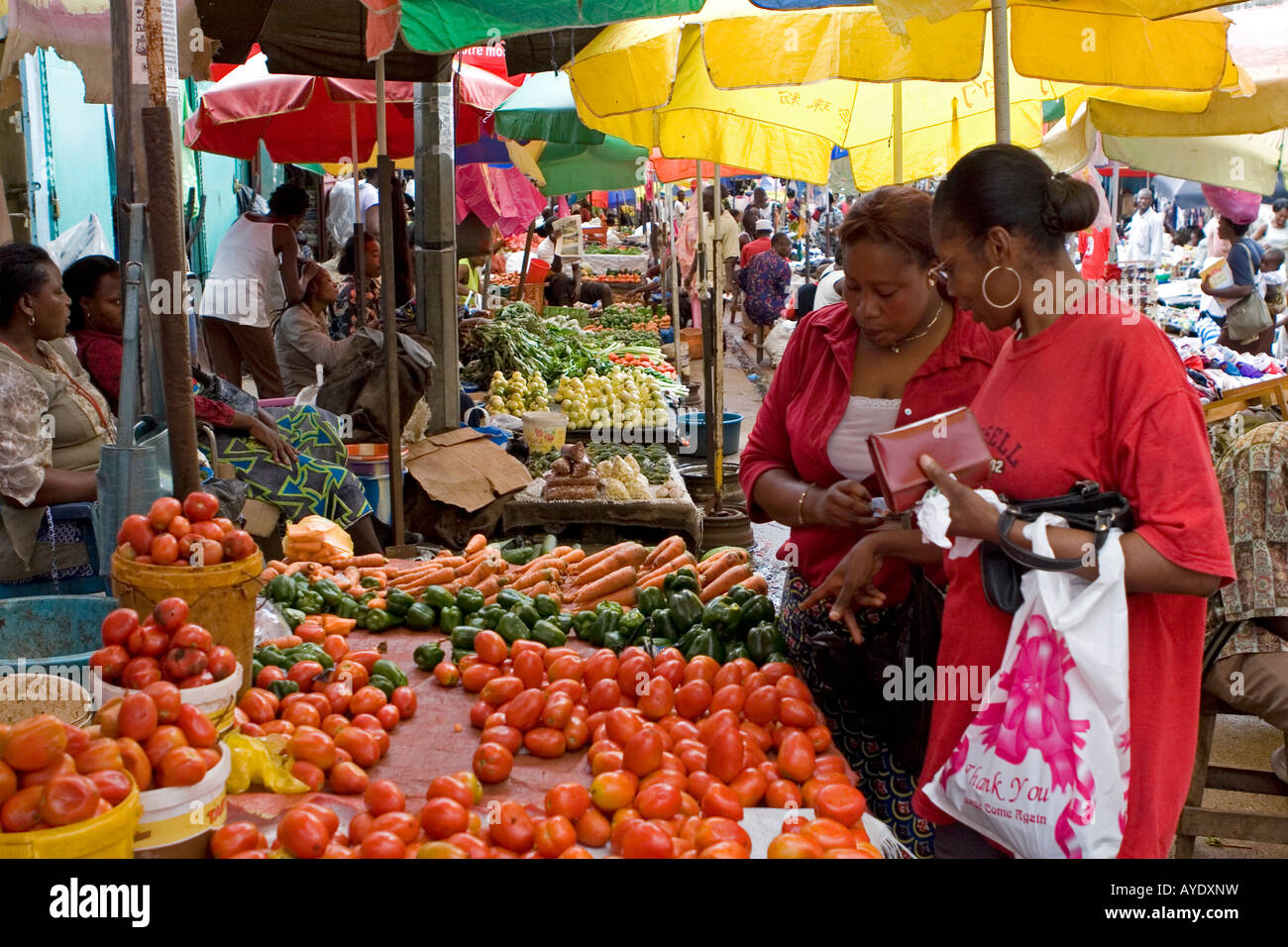African Gabonese woman buying tomatoes from a stallholder, Mont-Bouet ...
