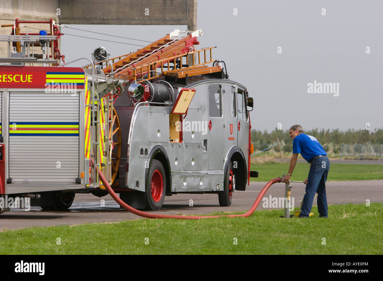 Refilling the water tank of an old vintage fire engine Stock Photo - Alamy