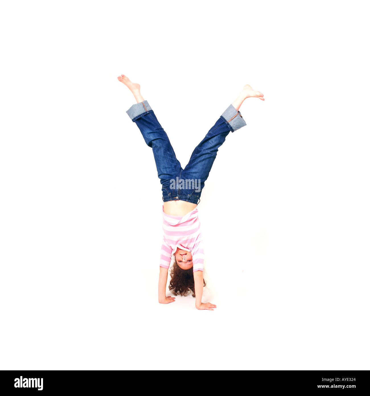 Girl doing cartwheel on white background Stock Photo - Alamy