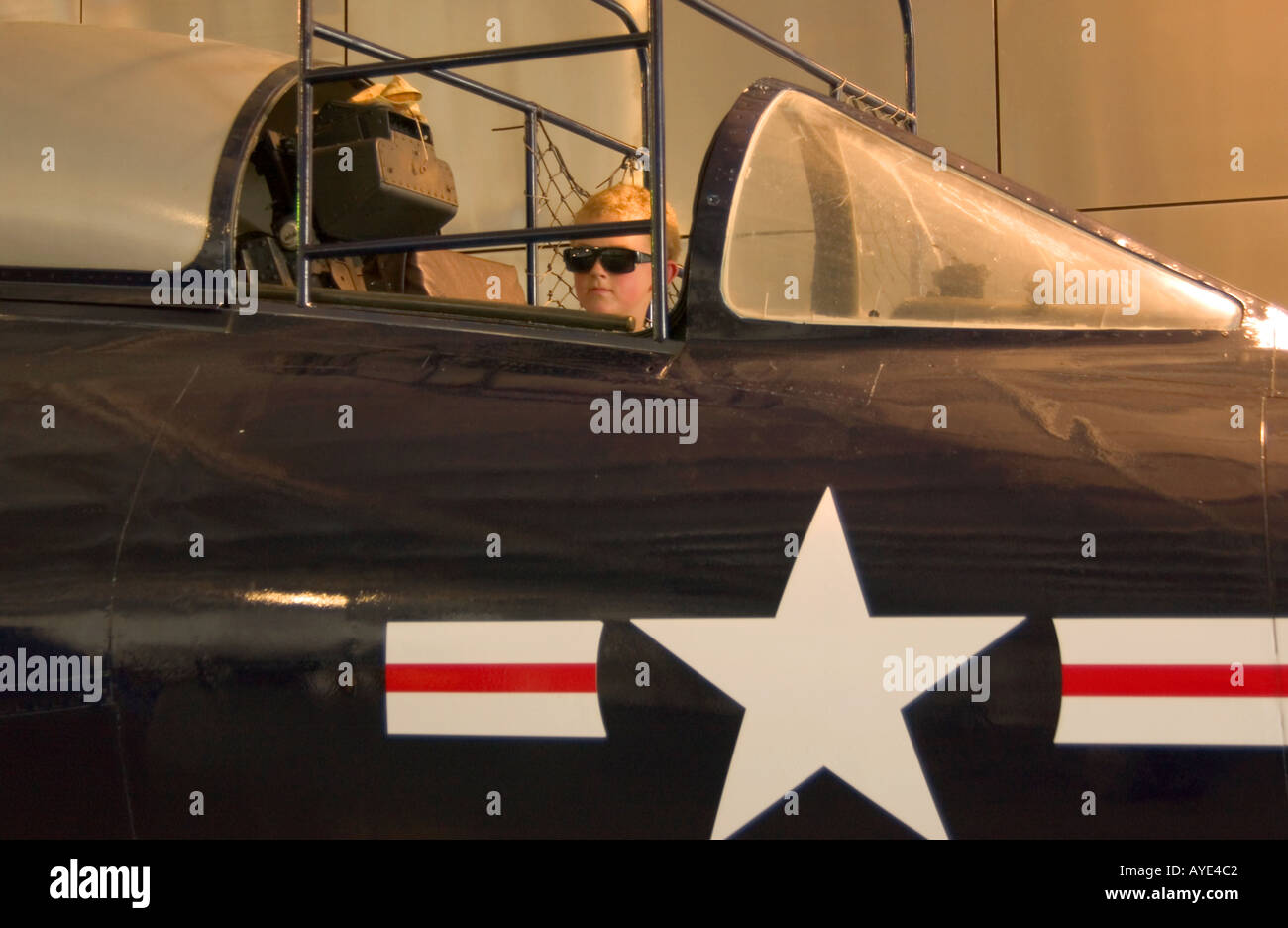 Kid sits in cockpit of jet fighter Stock Photo - Alamy