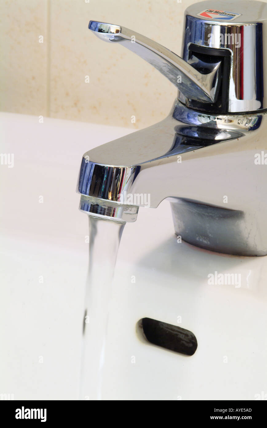 A tap in a bathroom running water Stock Photo - Alamy